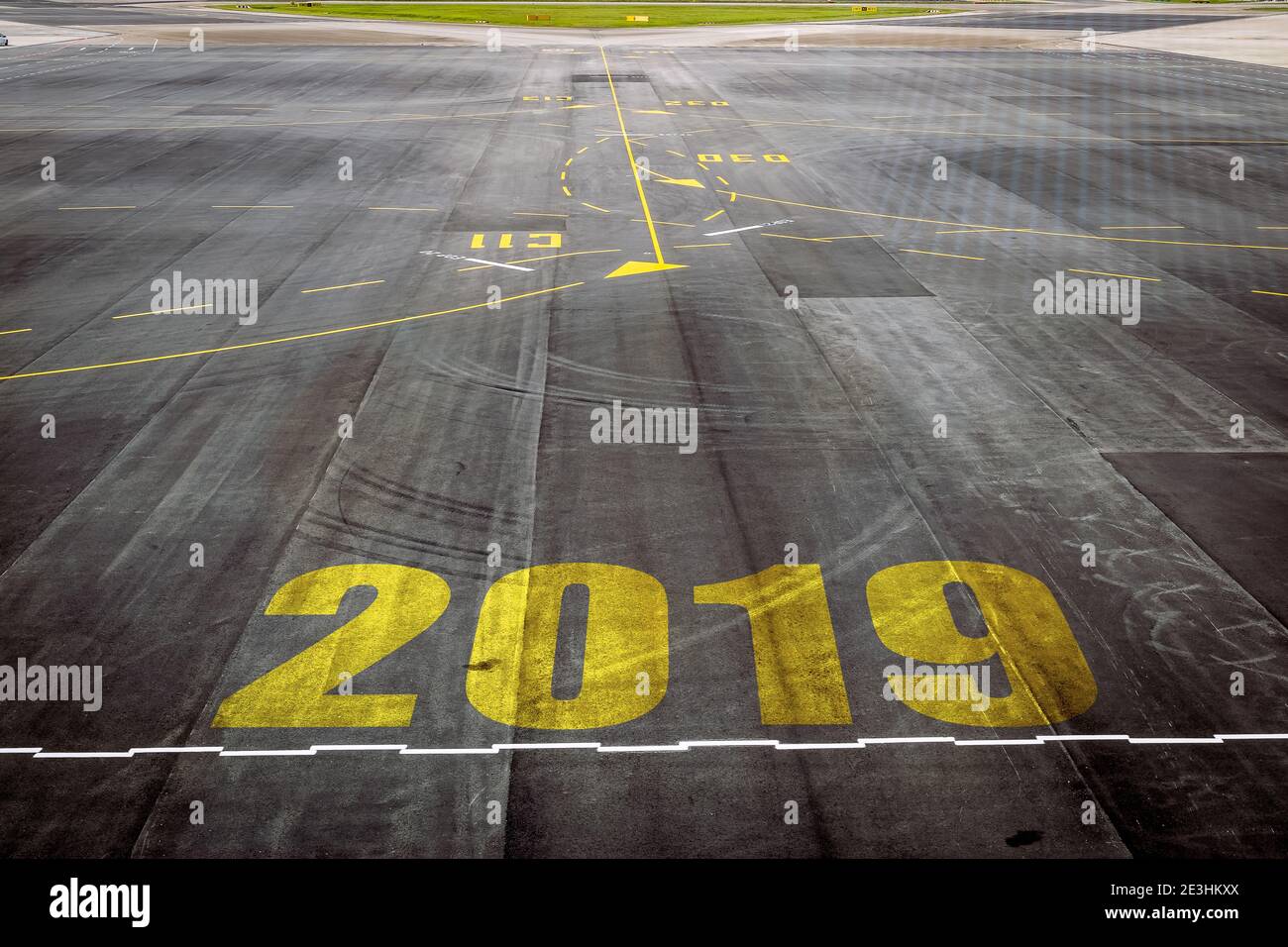 Closeup 2019 figures on the surface of the airport runway texture ...