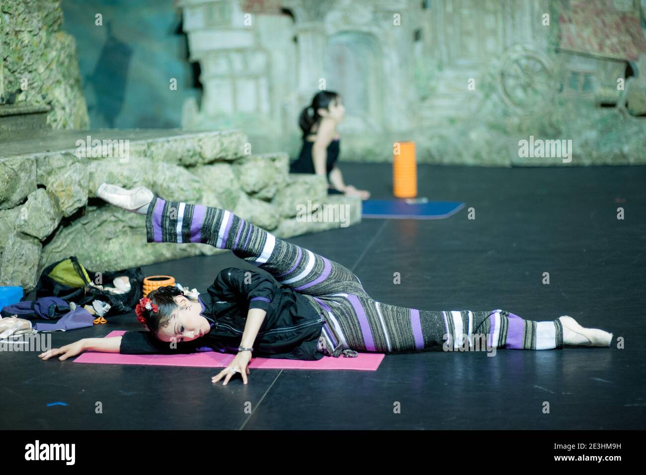 Ballerina in legwarmers with high leg kick Stock Photo - Alamy