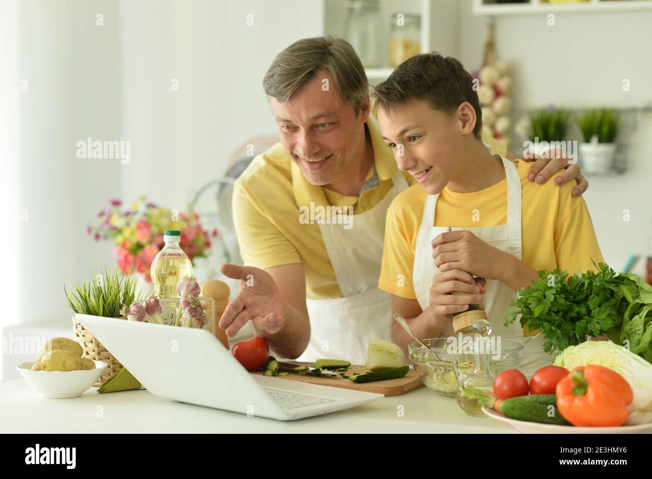 Portrait of man and boy cooking in kitchen Stock Photo - Alamy