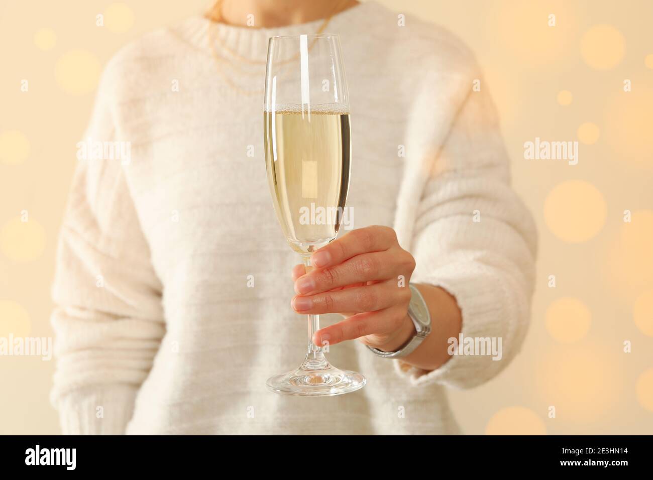 Young woman hold champagne glass, front view Stock Photo - Alamy