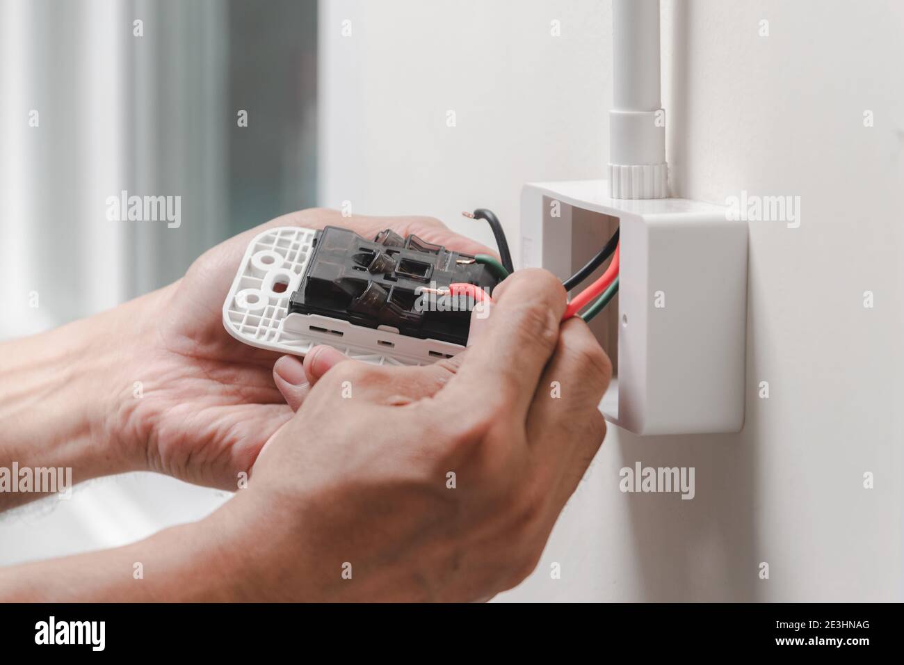 Young electrician installing socket hi-res stock photography and images ...