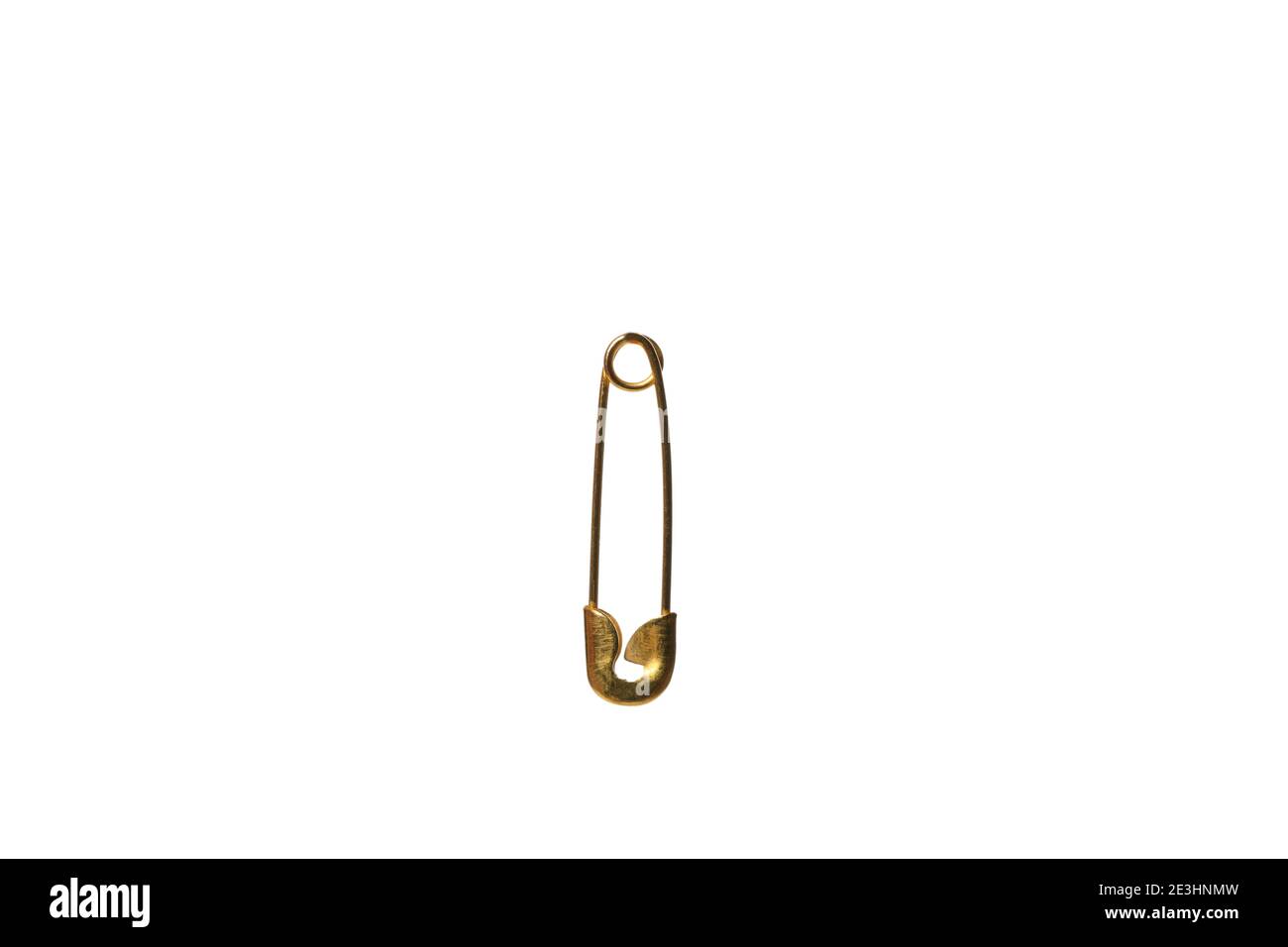 One golden safety pin isolated on white background Stock Photo - Alamy