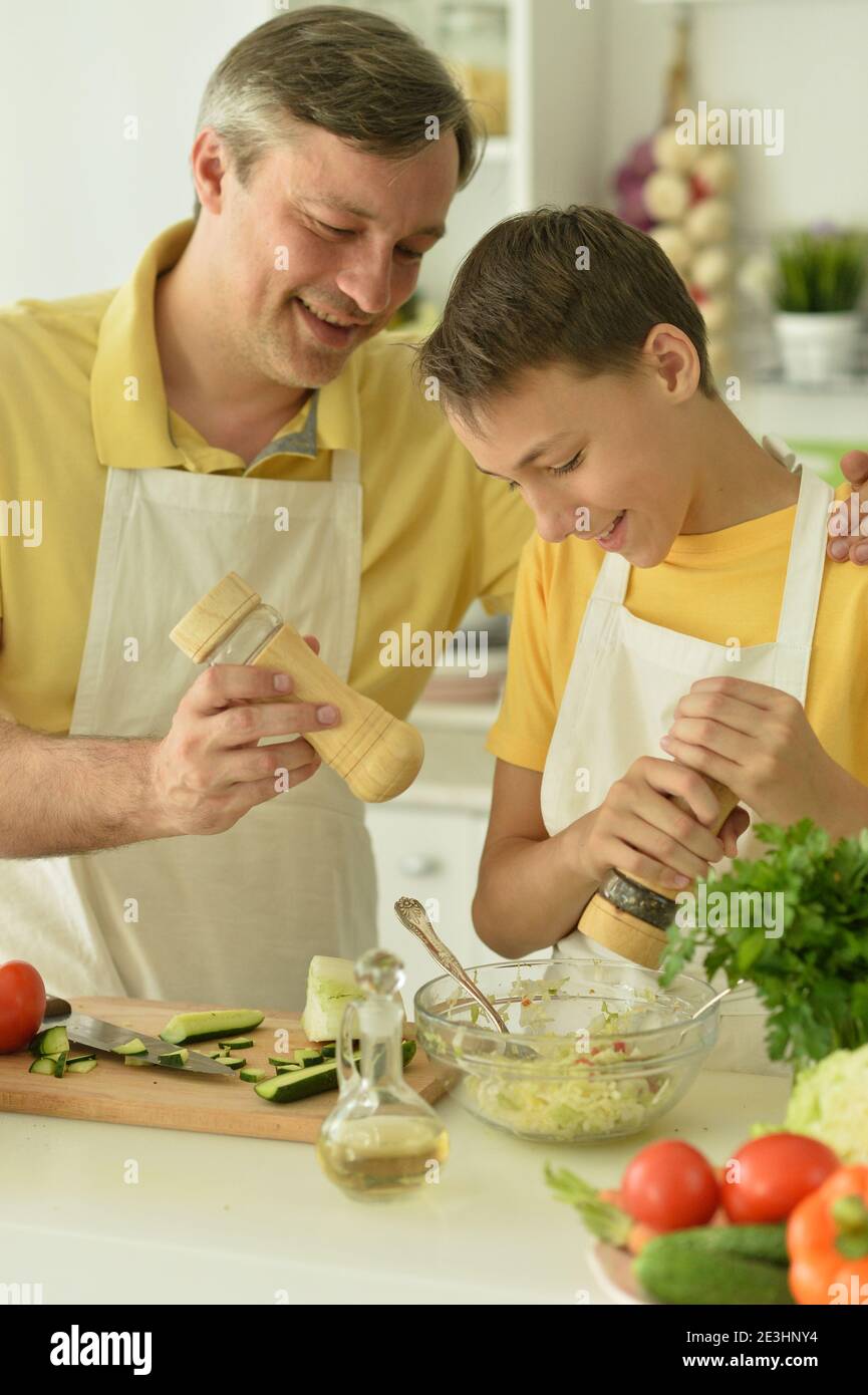 Portrait of man and boy cooking in kitchen Stock Photo - Alamy