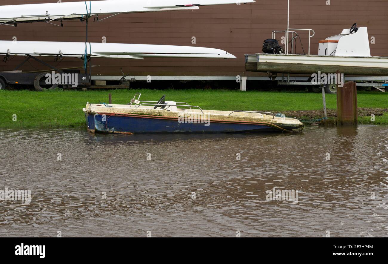 Small utility craft moored on a river Stock Photo - Alamy