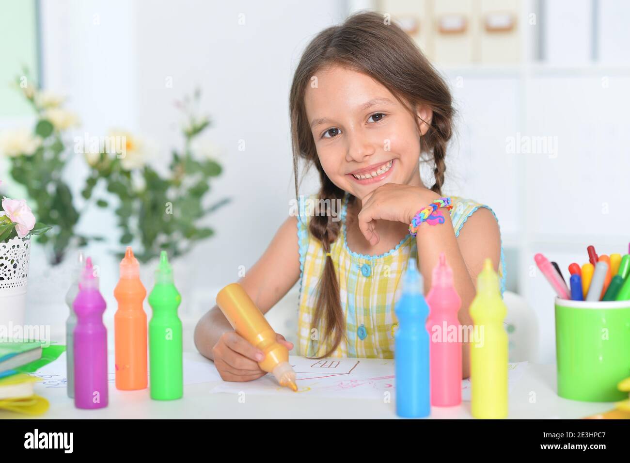 Portrait of smiling girl drawing at home Stock Photo - Alamy
