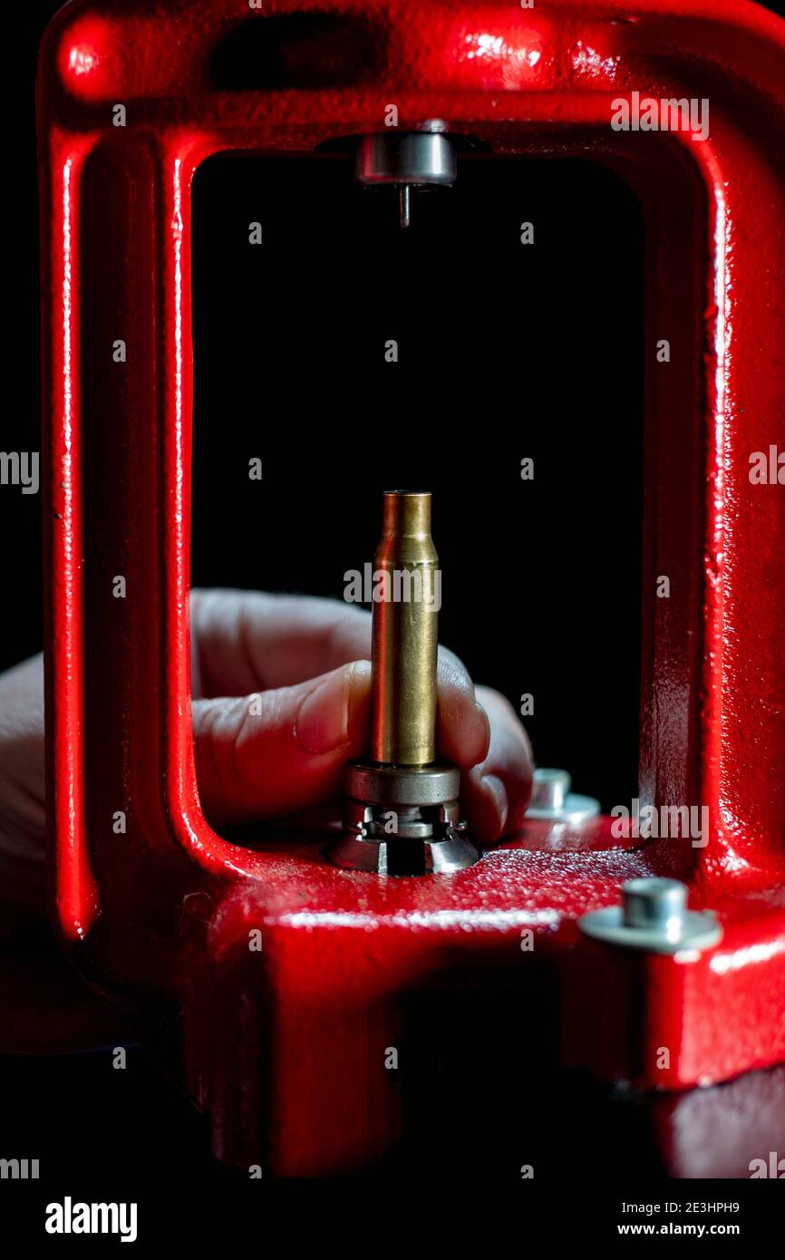 The process of making a rifle cartridge. Hand press and ammo shell ...