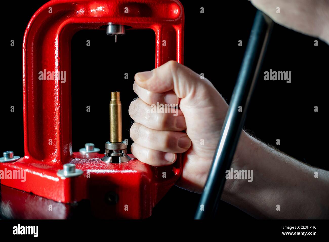 Red hand press and ammo shell against dark background, soft focus. Copy ...