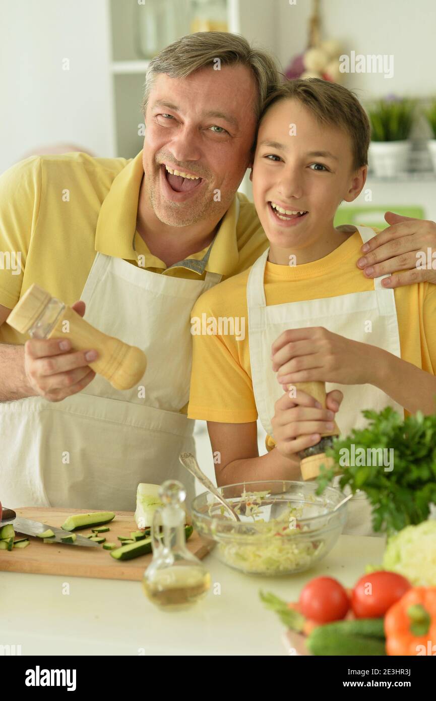 Portrait of man and boy cooking in kitchen Stock Photo - Alamy