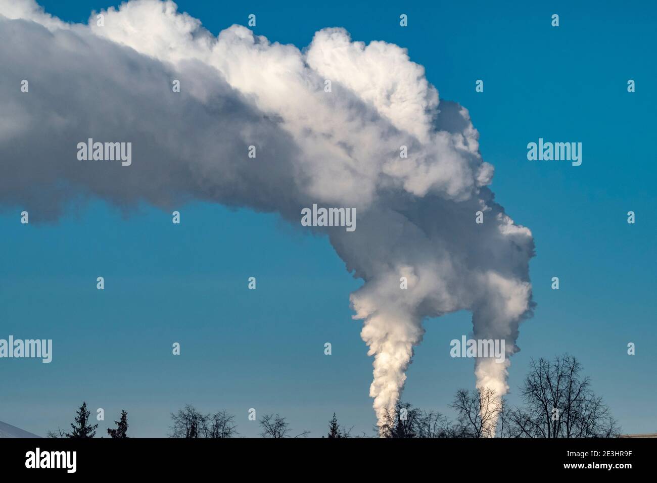 Russia, Moscow. Steam rises from cooling towers of a combined heat and ...