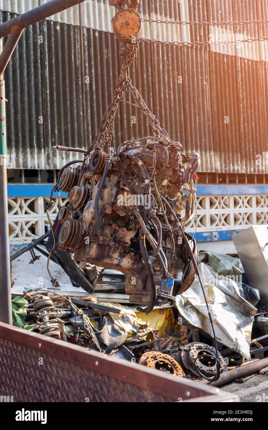Old or used car engine hanging on the crane in the garage, Automotive ...