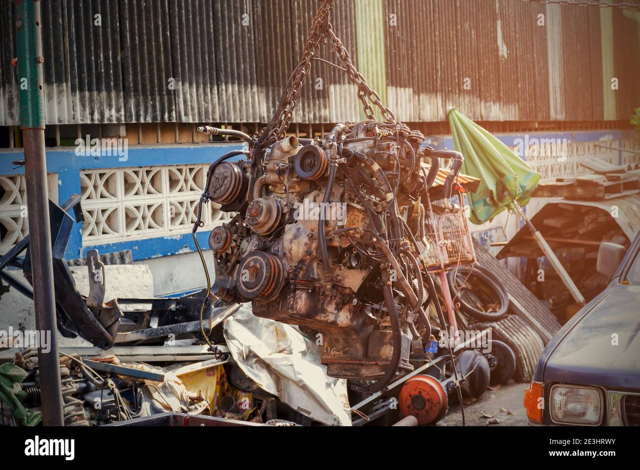 Old or used car engine hanging on the crane in the garage, Automotive ...