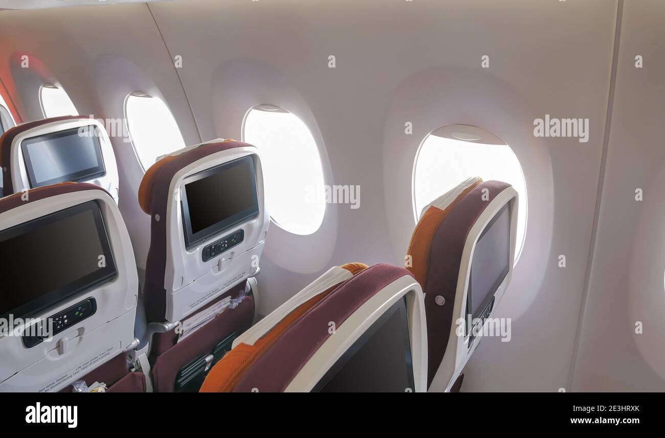 Closeup the window of the passenger plane and empty seats, concepts for ...