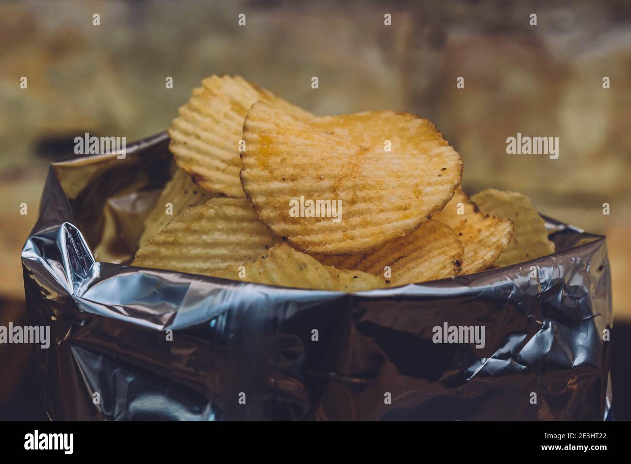 Close up pack of potato chips or crisps. Side view Stock Photo - Alamy
