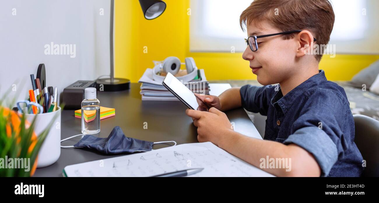 Teenager doing homework with a tablet Stock Photo - Alamy