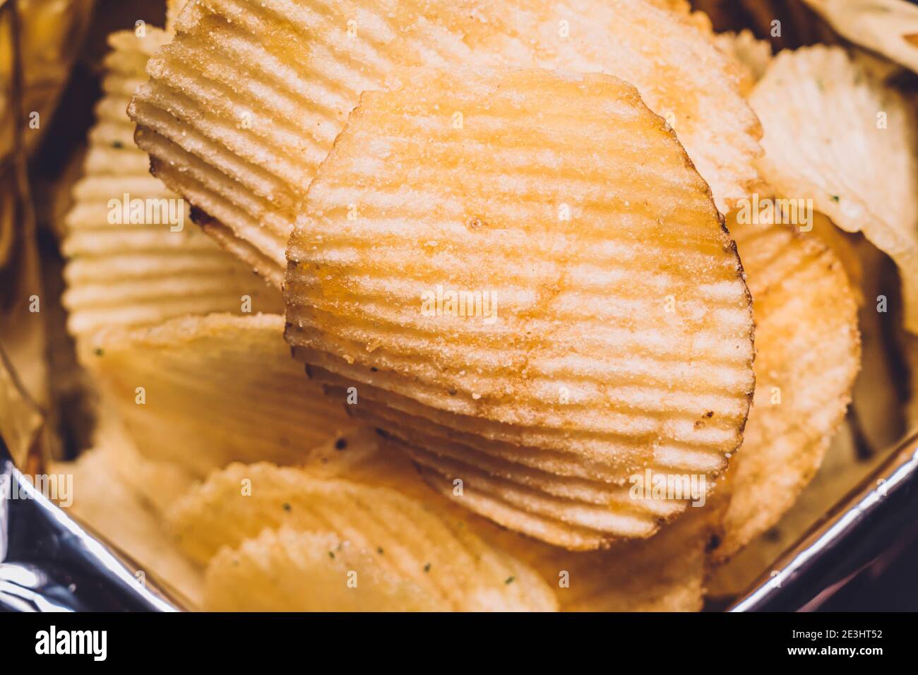 Close up top view of bag of chips or crisps isolated on black ...