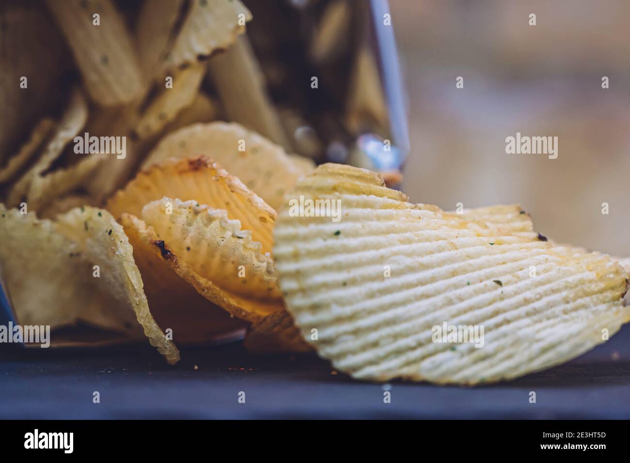 Close up of potato crisps or chips falling out of the pack Stock Photo ...