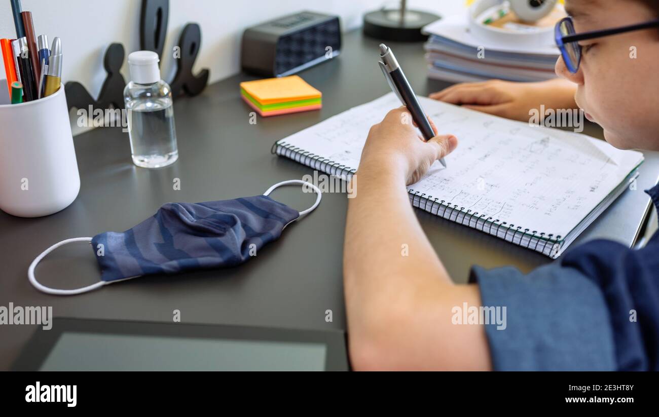 Teenager doing homework in his room Stock Photo - Alamy