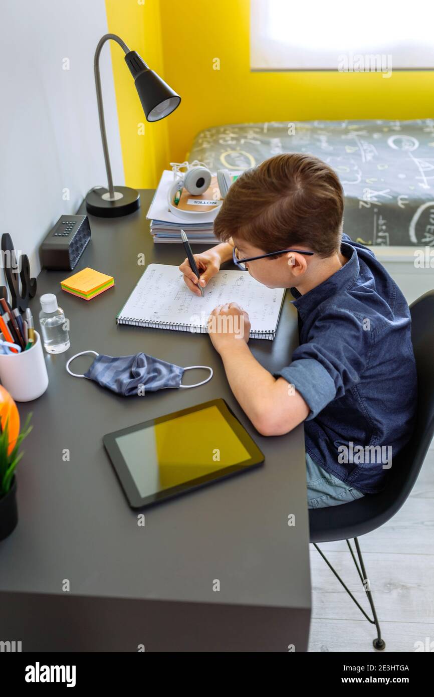 Teenager doing homework in his room Stock Photo - Alamy