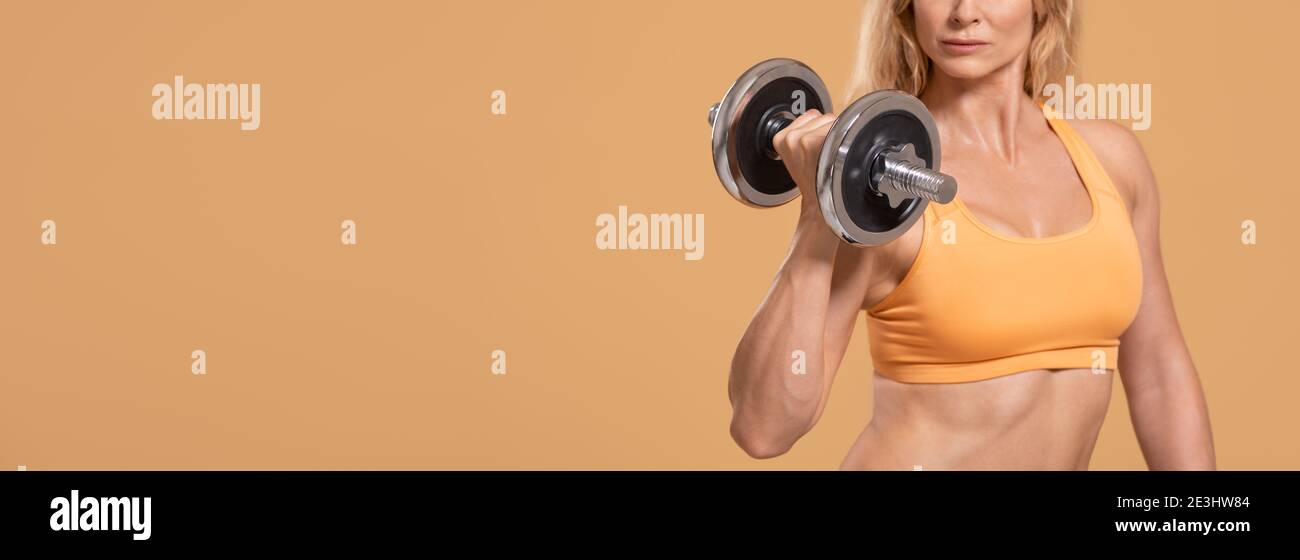 Lifts dumbbell for strength training, perfect body Stock Photo - Alamy