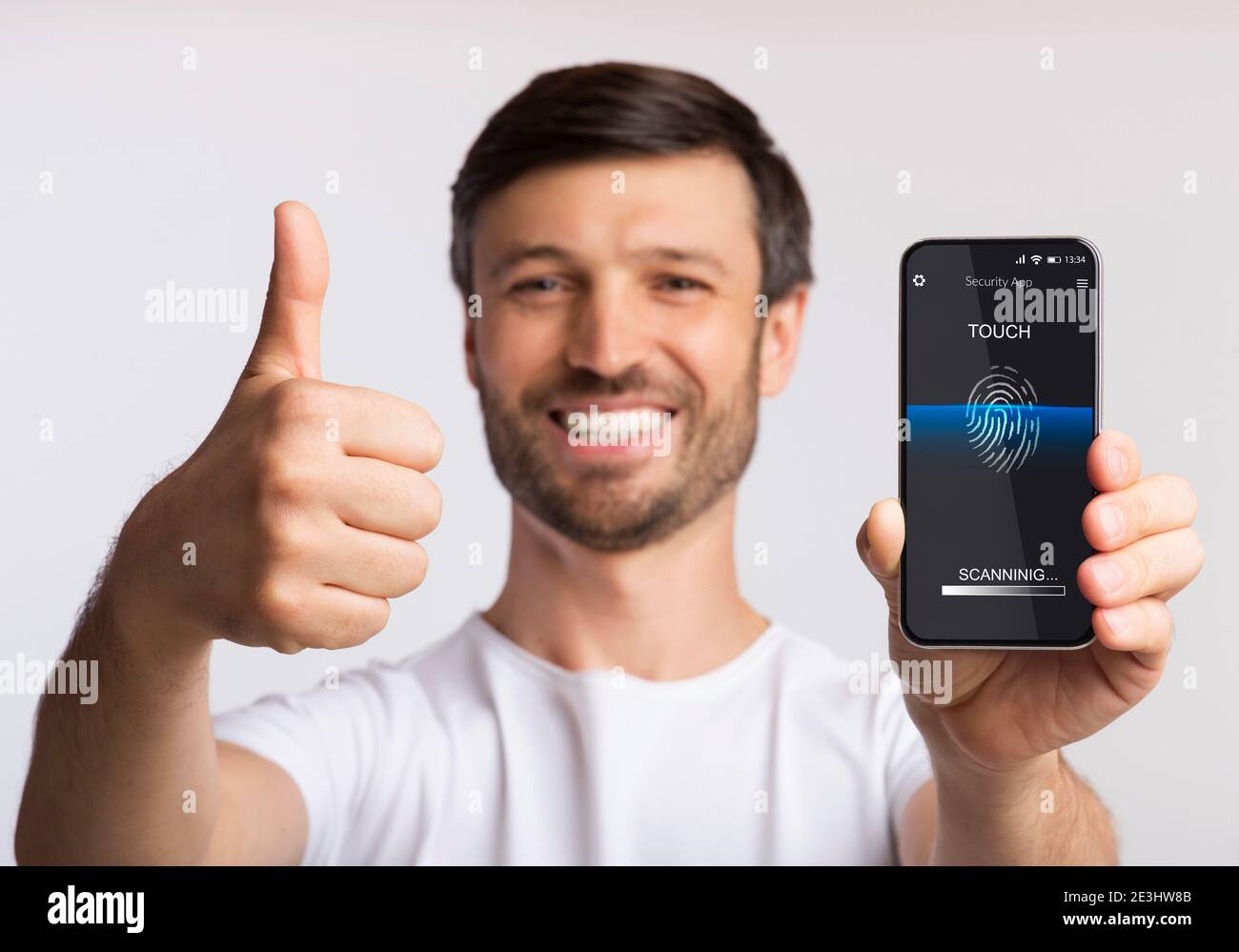 Man Showing Phone With Fingerprint Scanner Gesturing Thumbs-Up, White ...