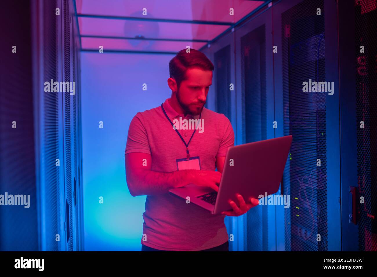 Male system administrator with laptop in datacenter Stock Photo - Alamy