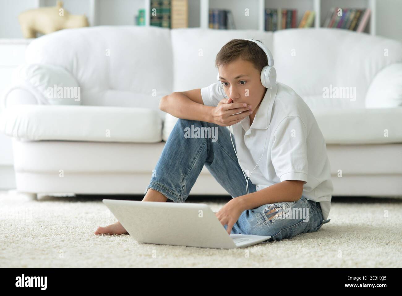 Boy using computer with headphones hi-res stock photography and images ...