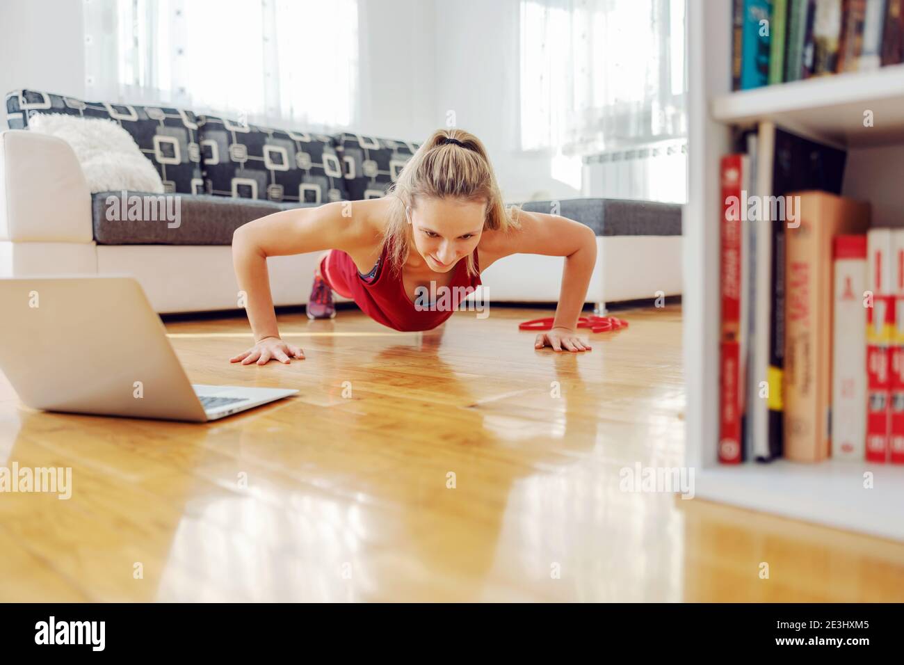 Strong fitness instructor doing pushups and having online class Stock Photo - Alamy
