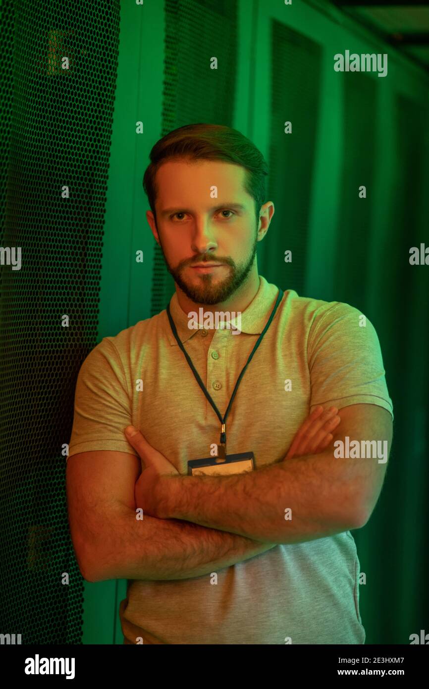 Calm muscular man with folded arms on chest Stock Photo - Alamy