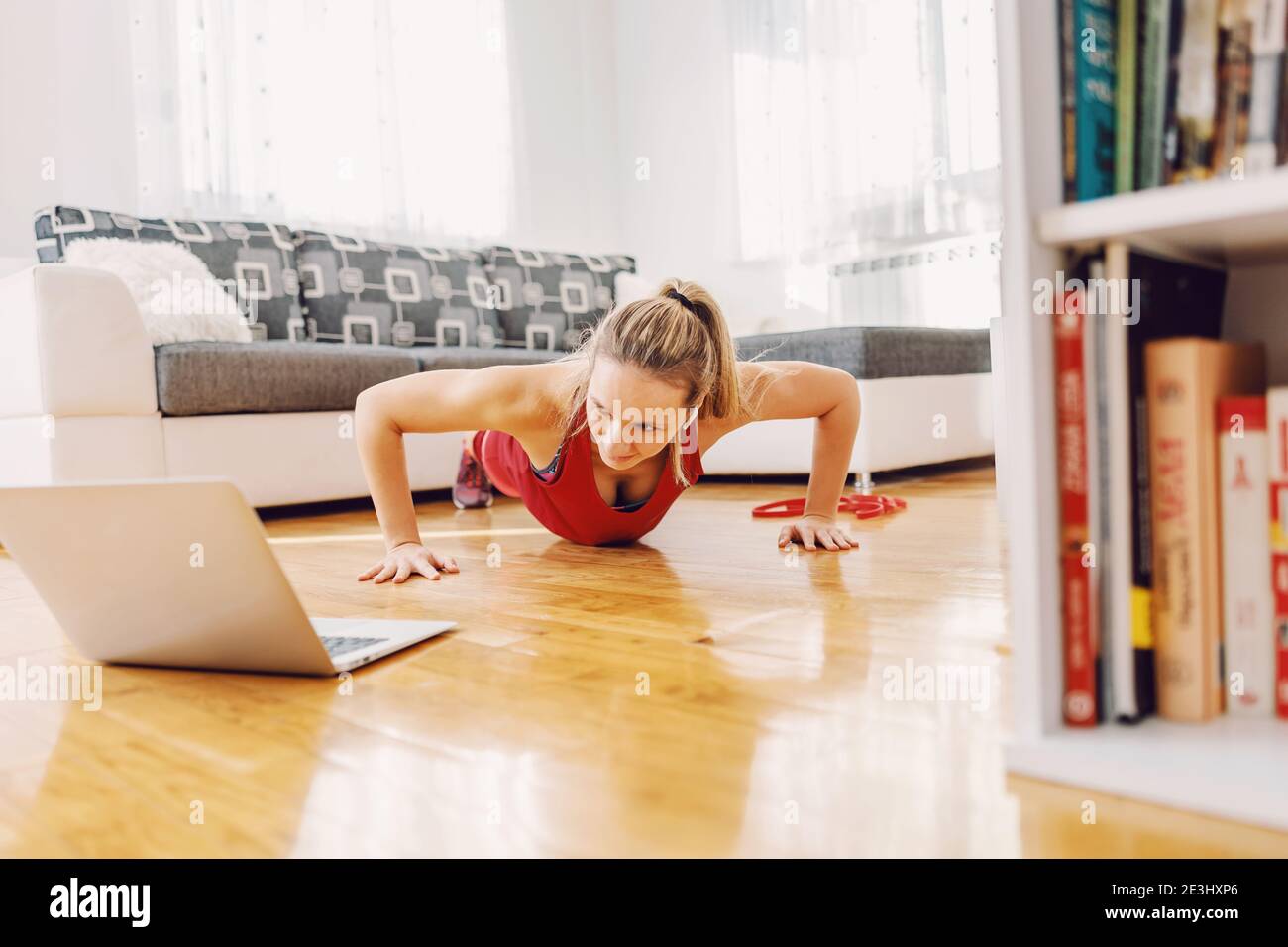 Strong fitness instructor doing pushups and having online class Stock Photo - Alamy