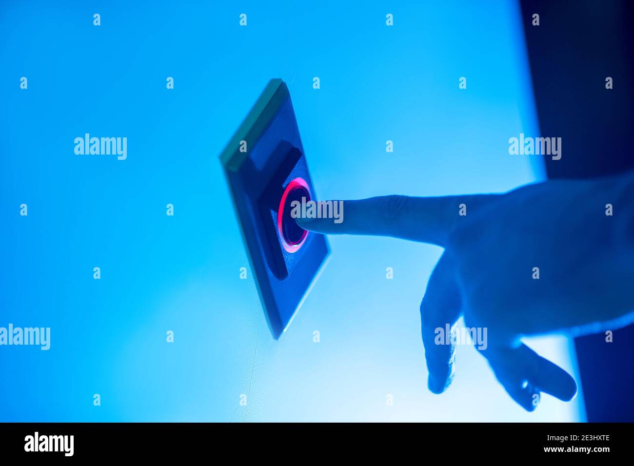 Finger pressing button on the wall Stock Photo - Alamy