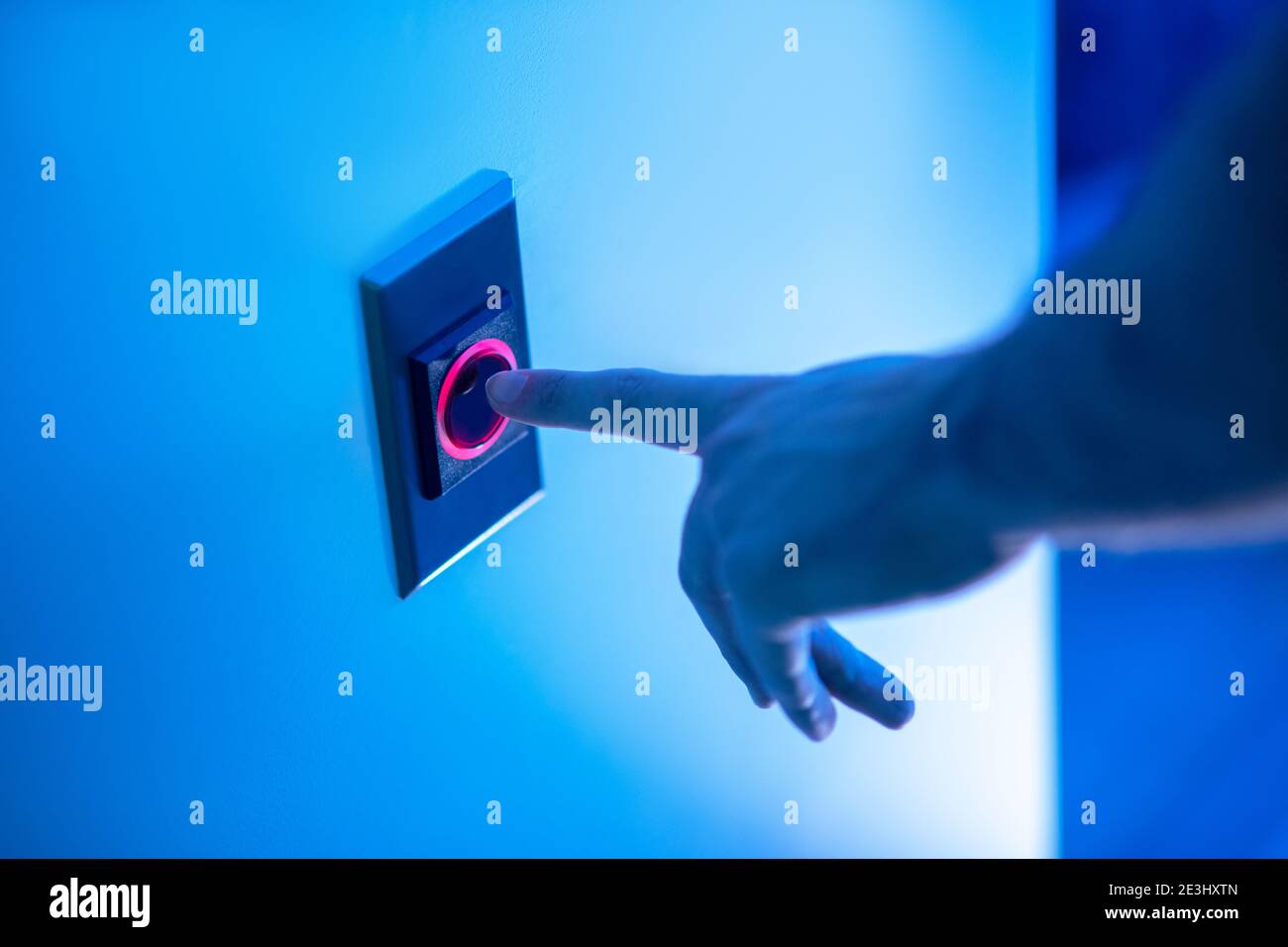 Hand approaching button on the wall Stock Photo - Alamy