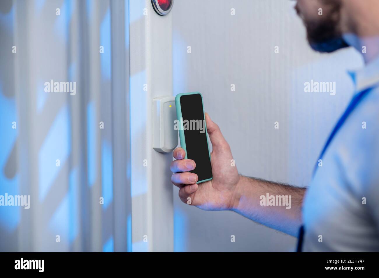 Male hand applying smartphone to scanner Stock Photo - Alamy