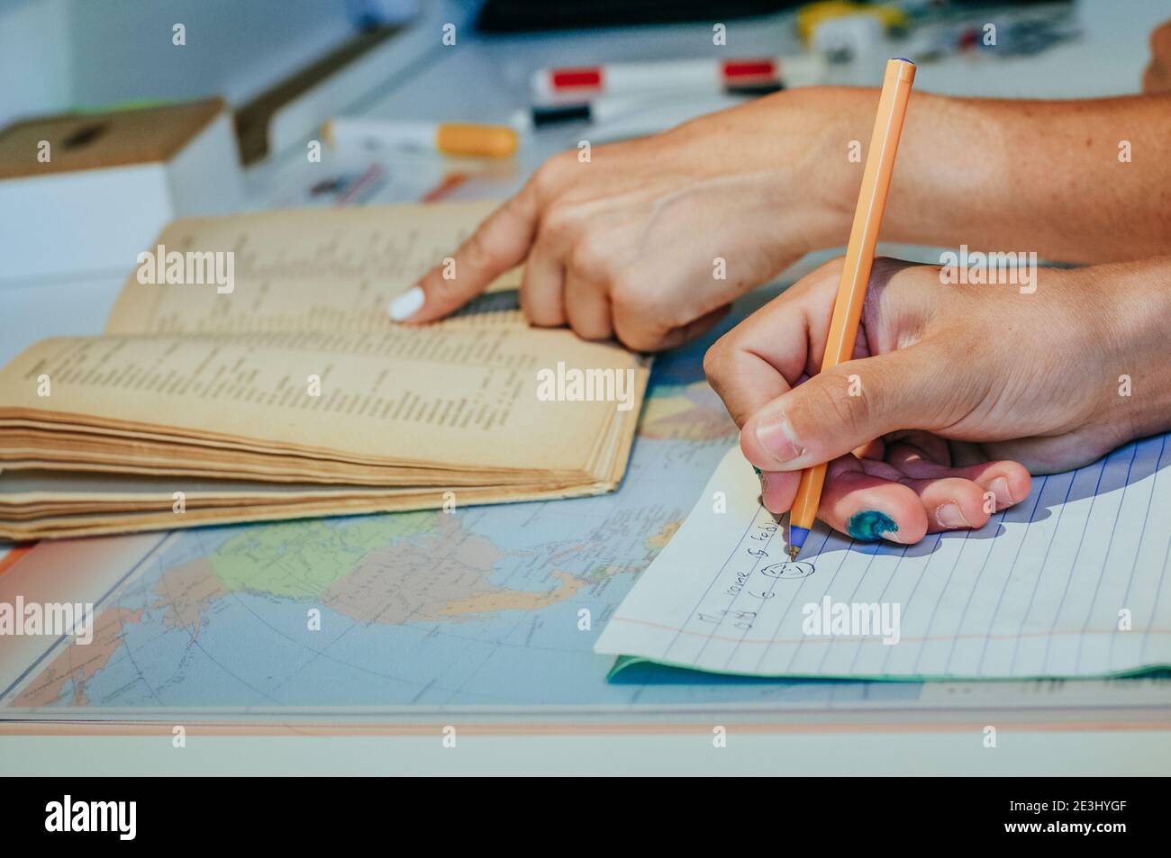Close up of teenager boy's hand writing in the exersice book doing his ...