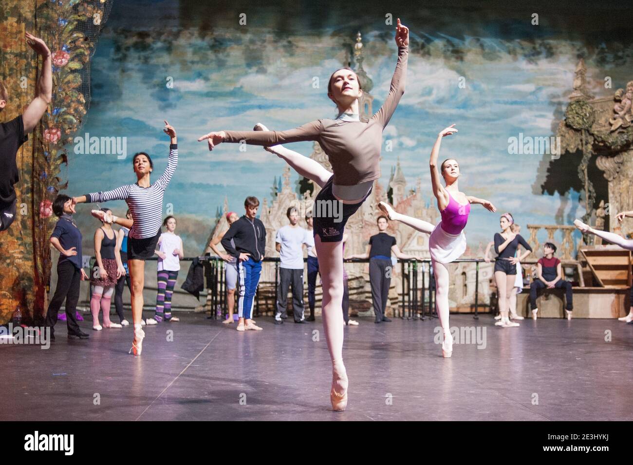 Ballet dancer on stage during company class with stage scenery in ...