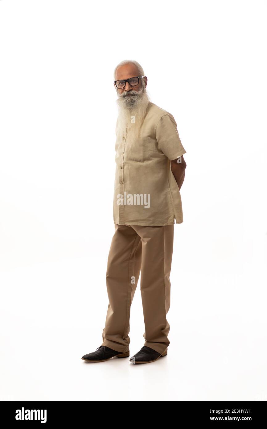 A BEARDED MAN STANDING AND SERIOUSLY LOOKING AWAY Stock Photo - Alamy