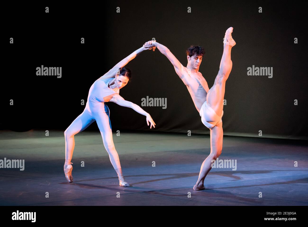Dynamic ballet duet performed on stage by dancers with amazing muscular ...