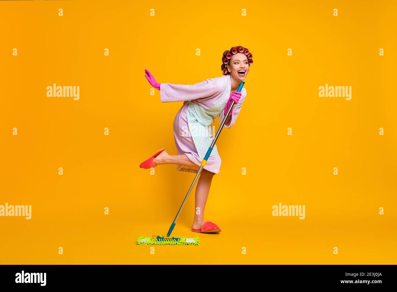 Full length body size view of cheerful glamorous maid using mop like ...