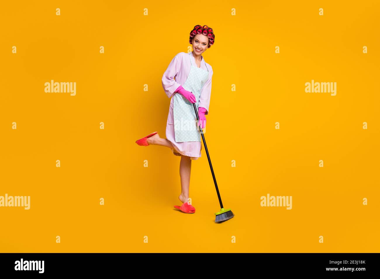 Full length body size view of attractive cheerful maid jumping sweeping ...