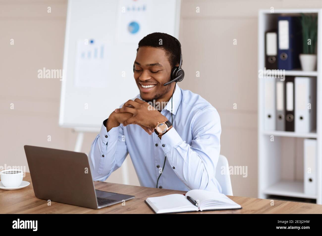 Happy black man having online training, office interior Stock Photo - Alamy