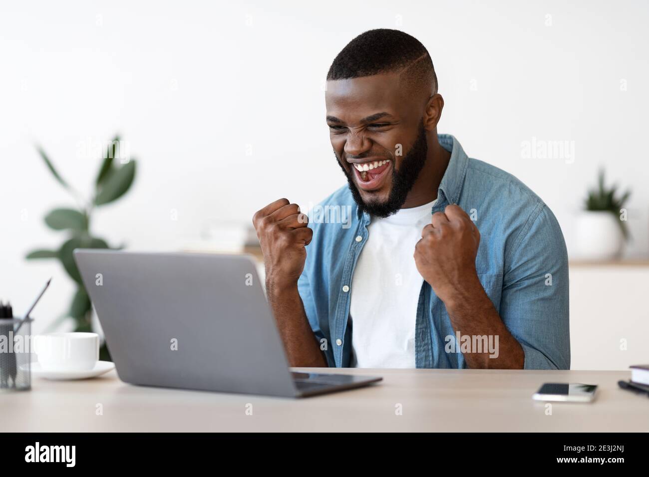 Joyful Black Guy With Laptop Raising Fists At Workplace, Celebrating ...