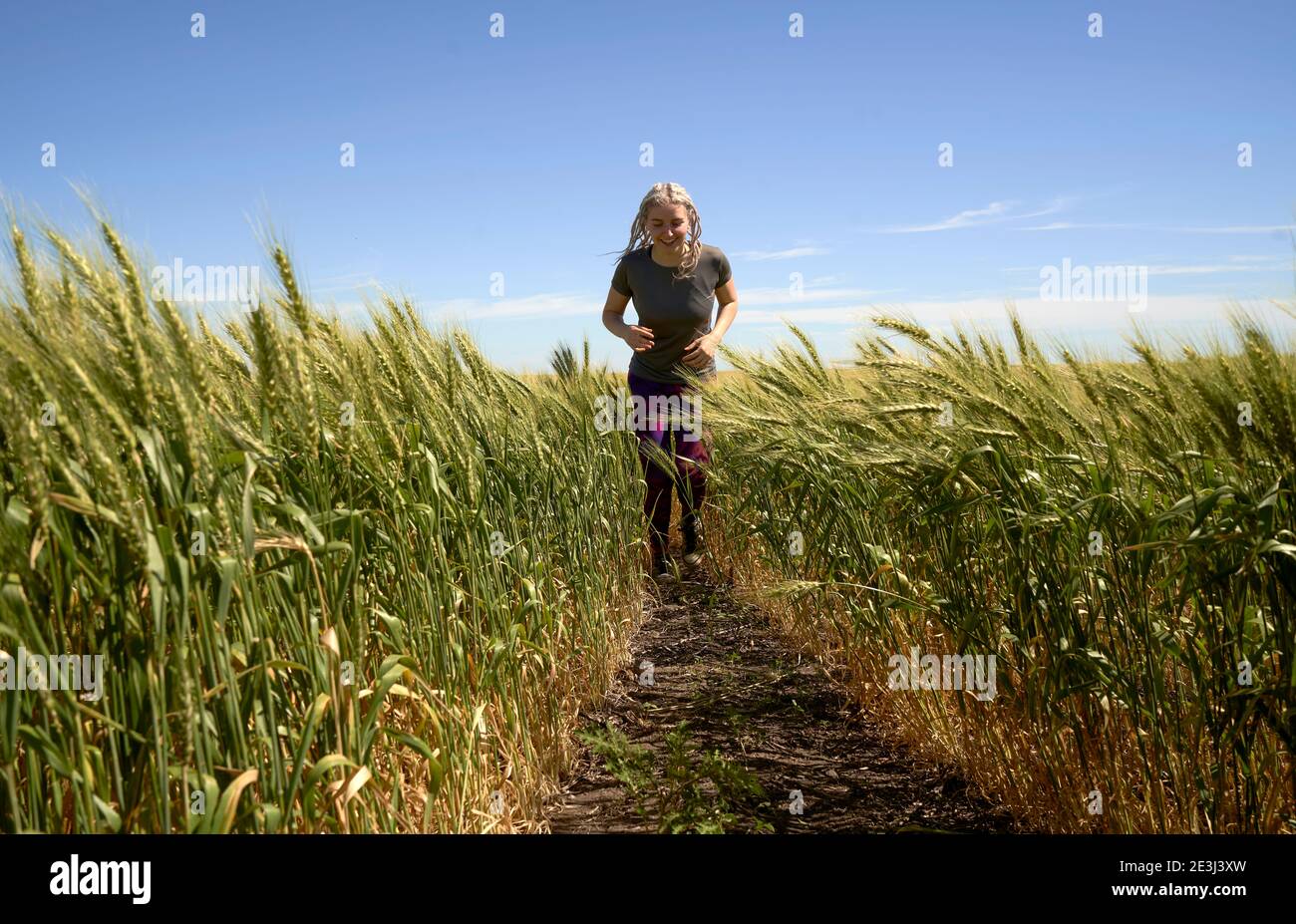 Running In The Wheat Young teen girl running through wheat field in ...