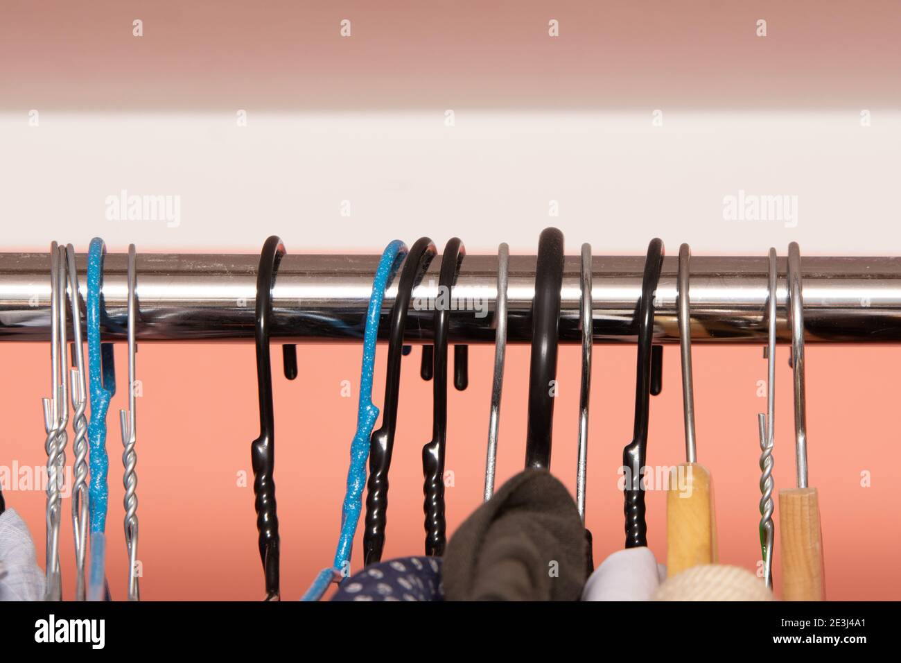different hangers hanging on the tube Stock Photo - Alamy