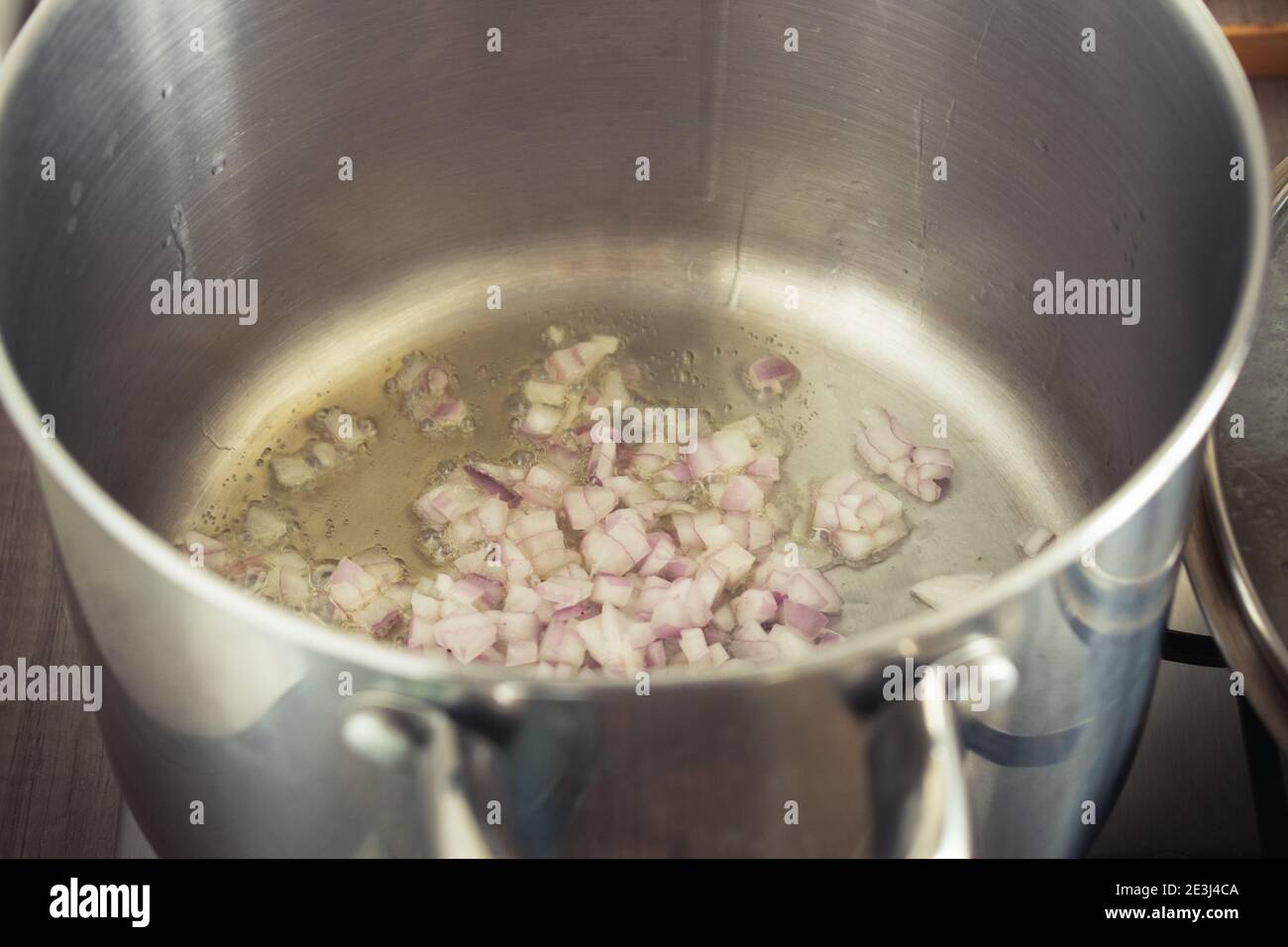 chopped onion in a pot with oil Stock Photo - Alamy