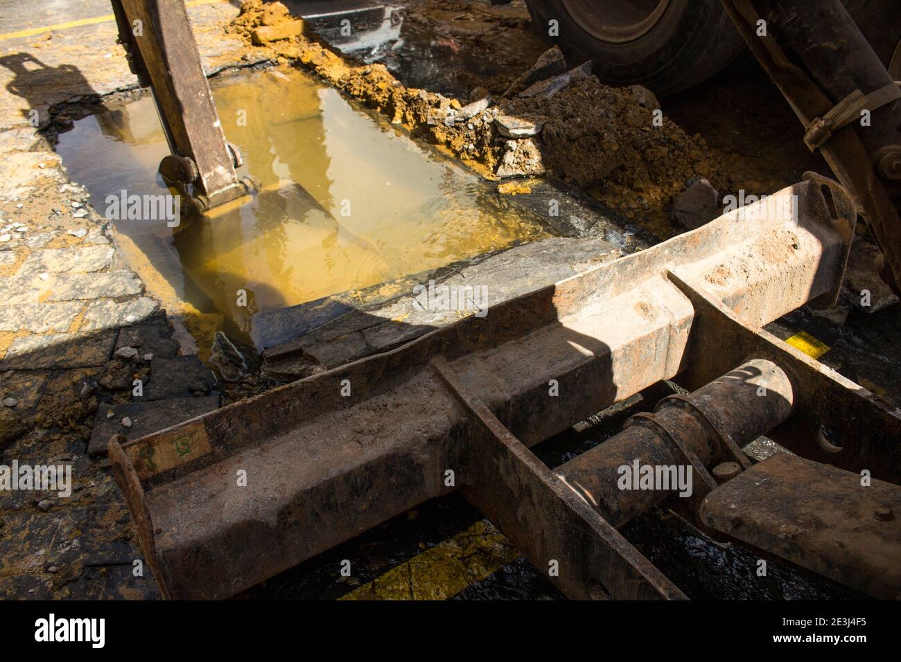 Heavy machinery digging and fixing an dangerous sewerage system on open ...