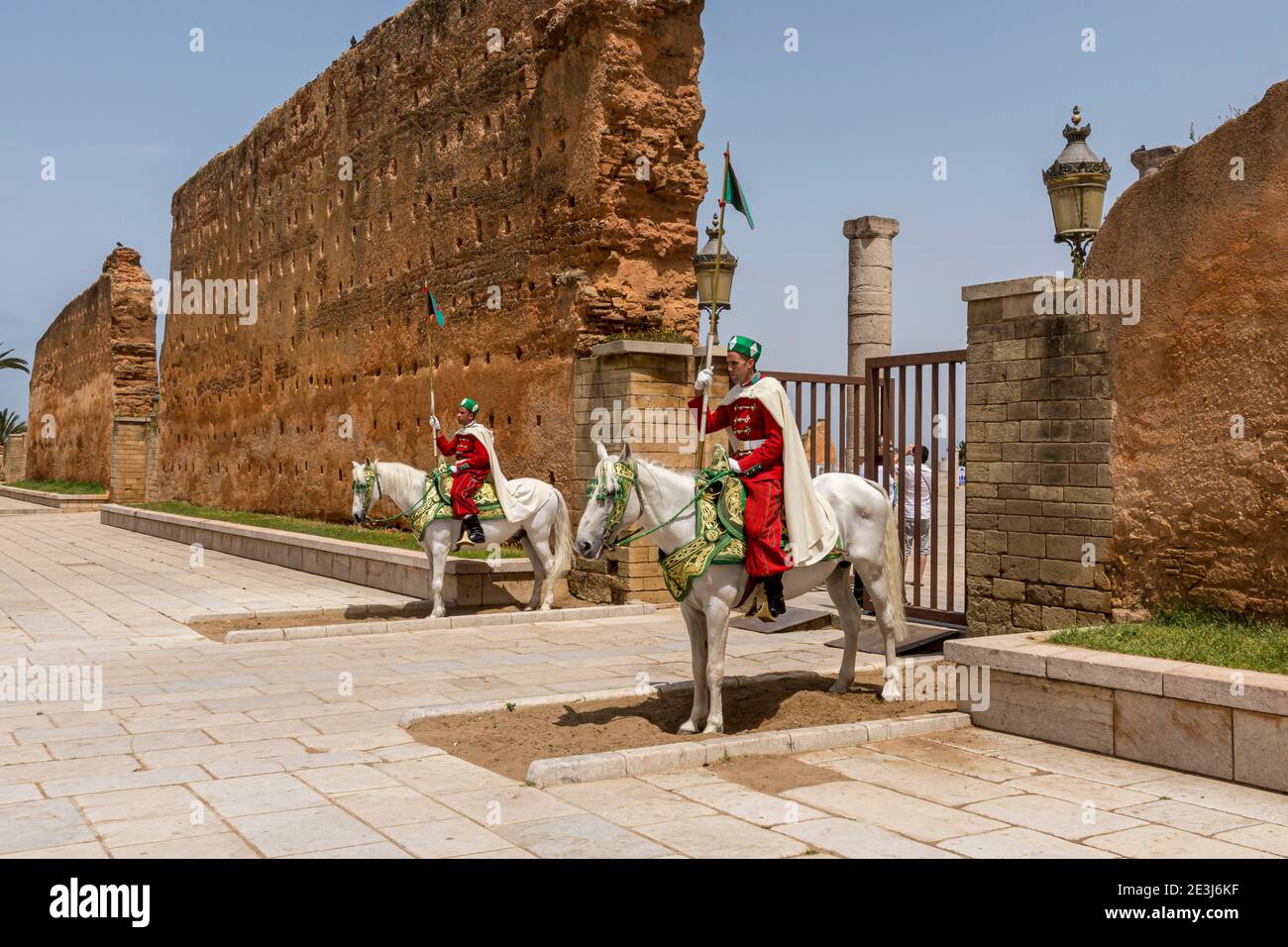 Guards at the entrance and walls to a ruined mosque at Hassan Tower and ...