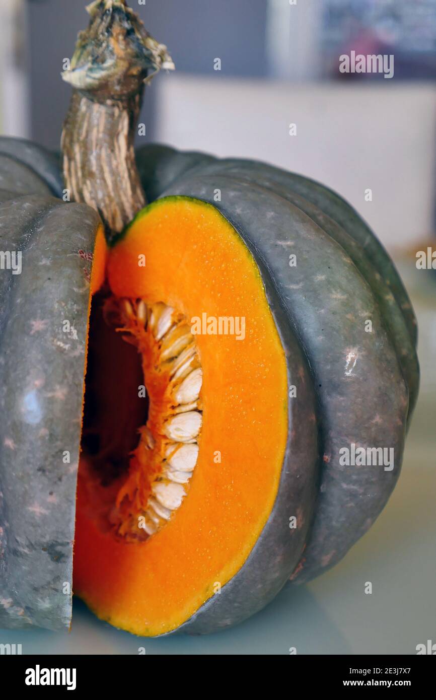 Cut the organic pumpkin into slices with a knife Stock Photo - Alamy