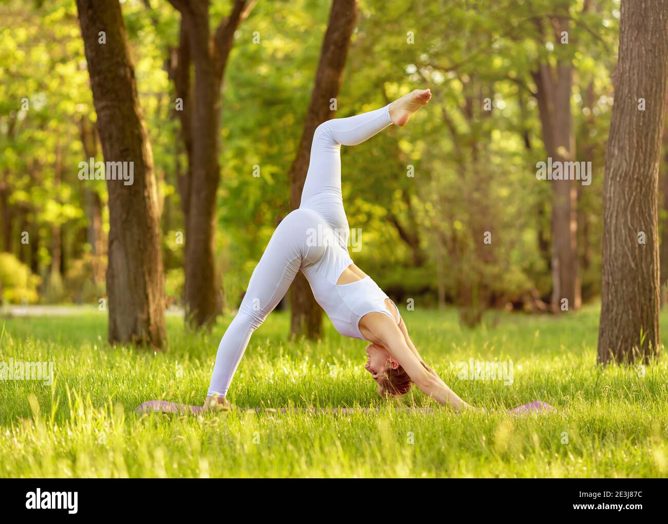 Beautiful woman practicing yoga in morning light. Yoga poses Stock ...
