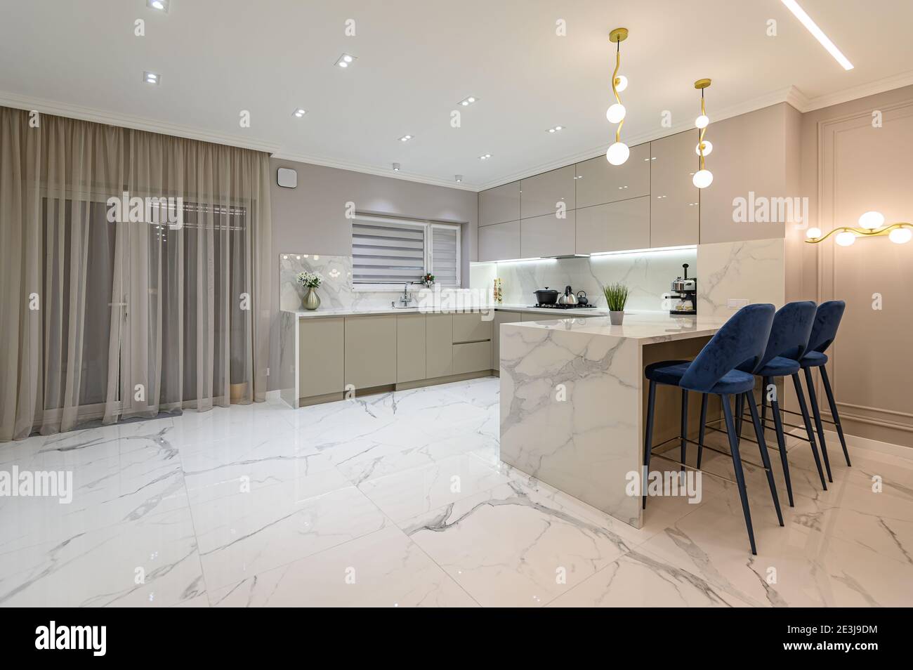 Luxury white modern marble kitchen in studio space Stock Photo - Alamy