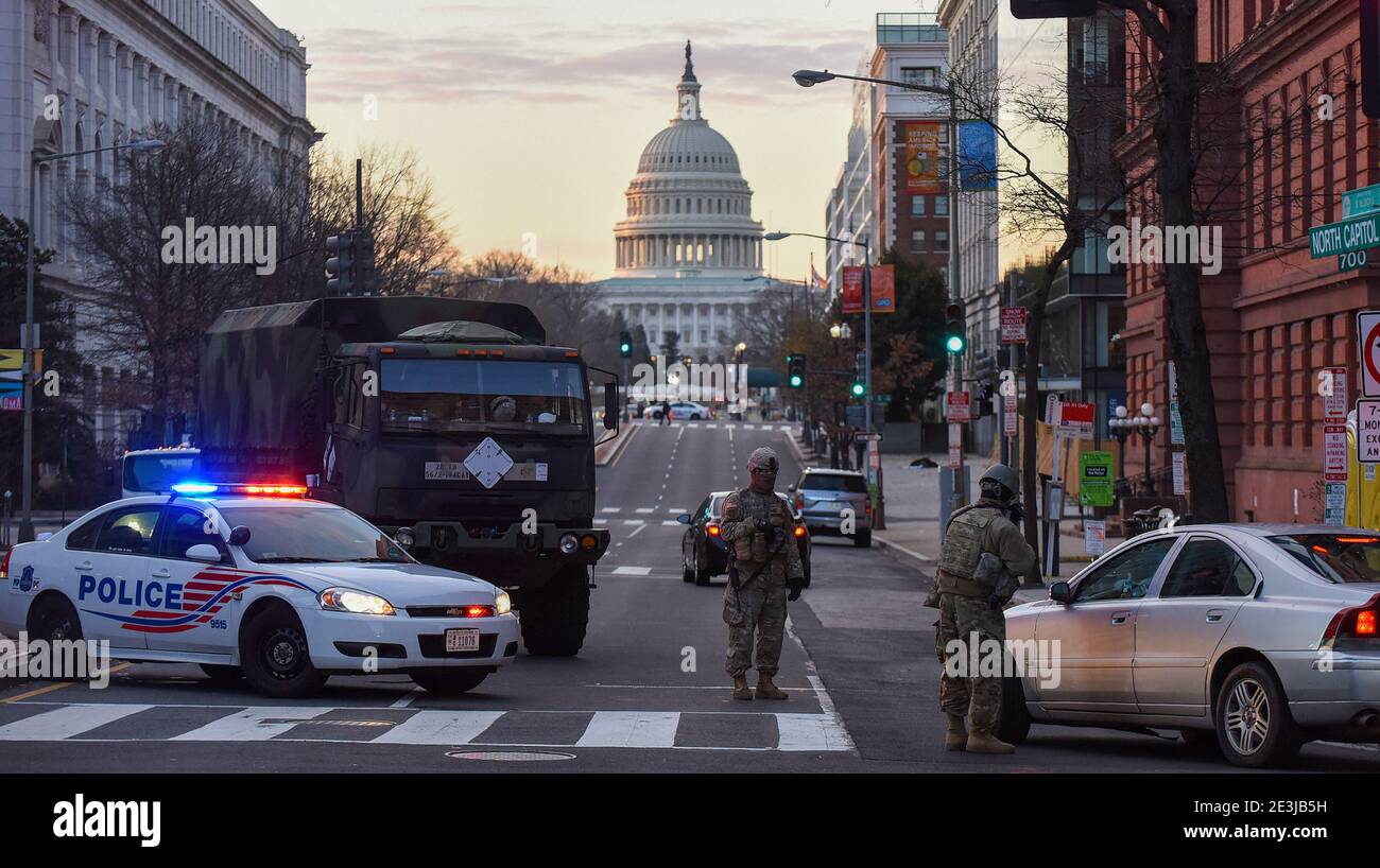 Police and National Guard soldiers stop vehicles at a checkpoint near ...