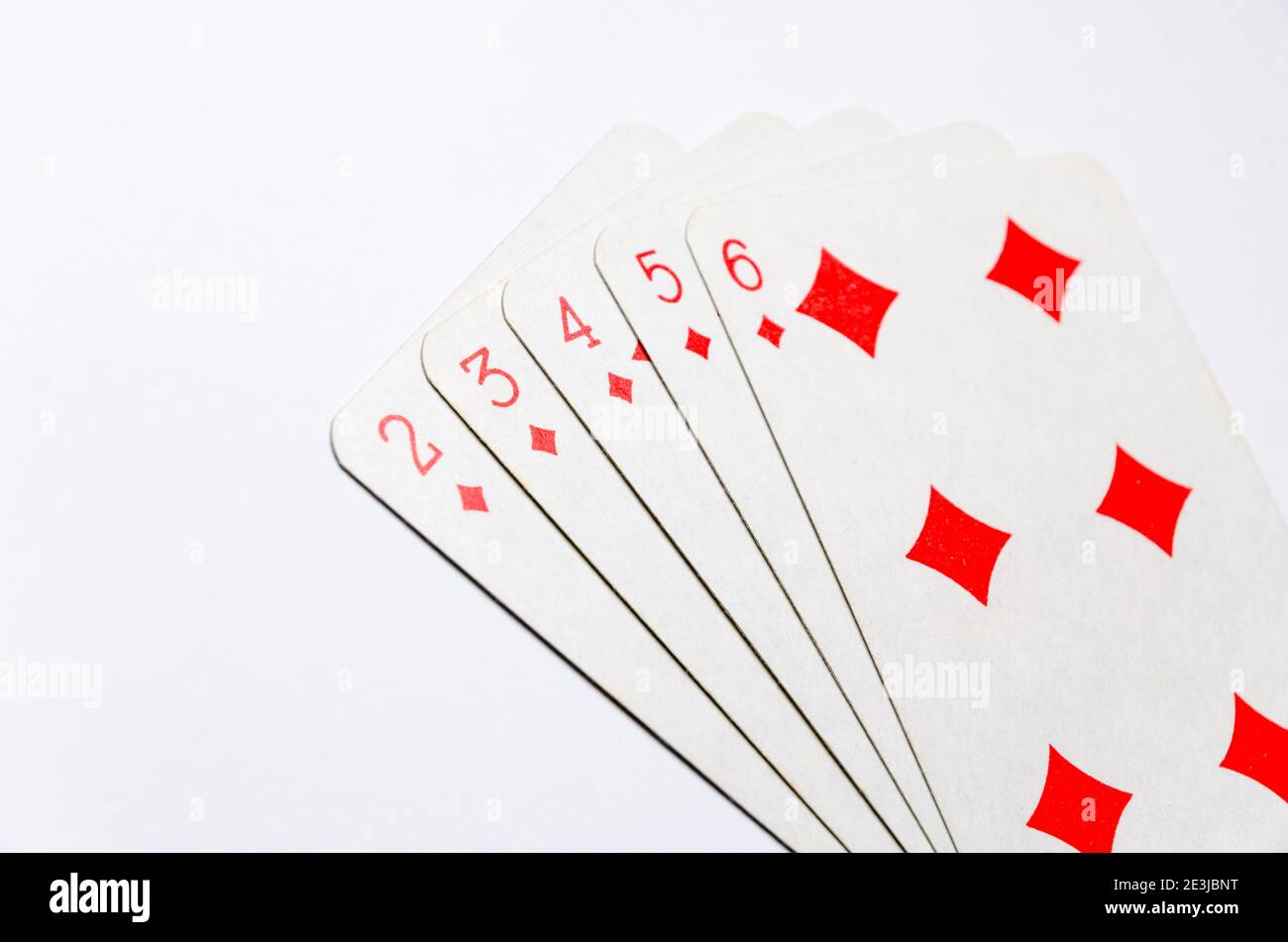 Playing cards on white background, poker game hand, straight flush ...